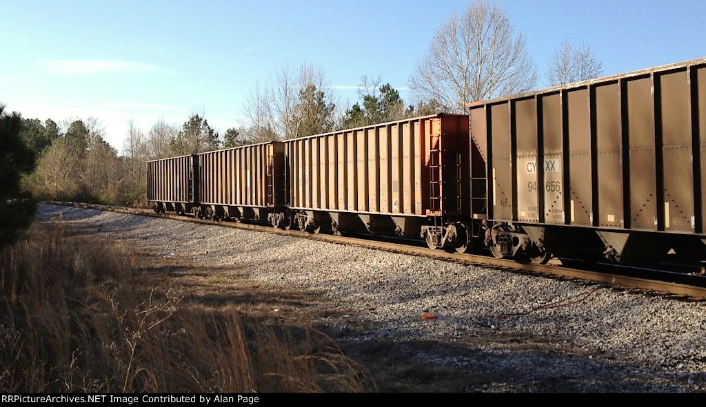 PMRX 48344 heads NB at the tail end of a line of empty hoppers